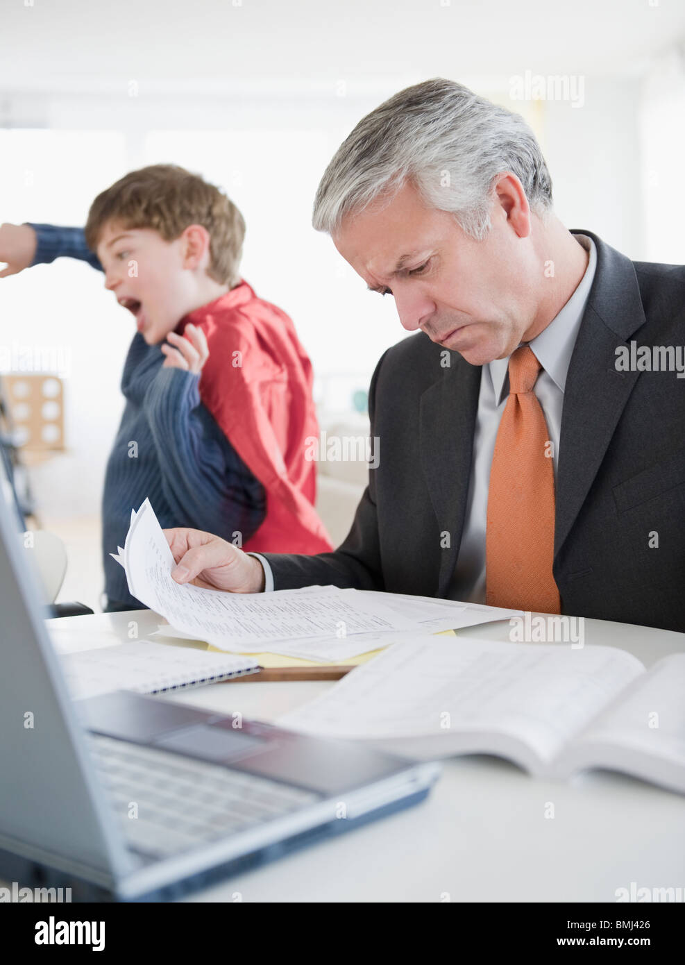 Father working at home Stock Photo - Alamy
