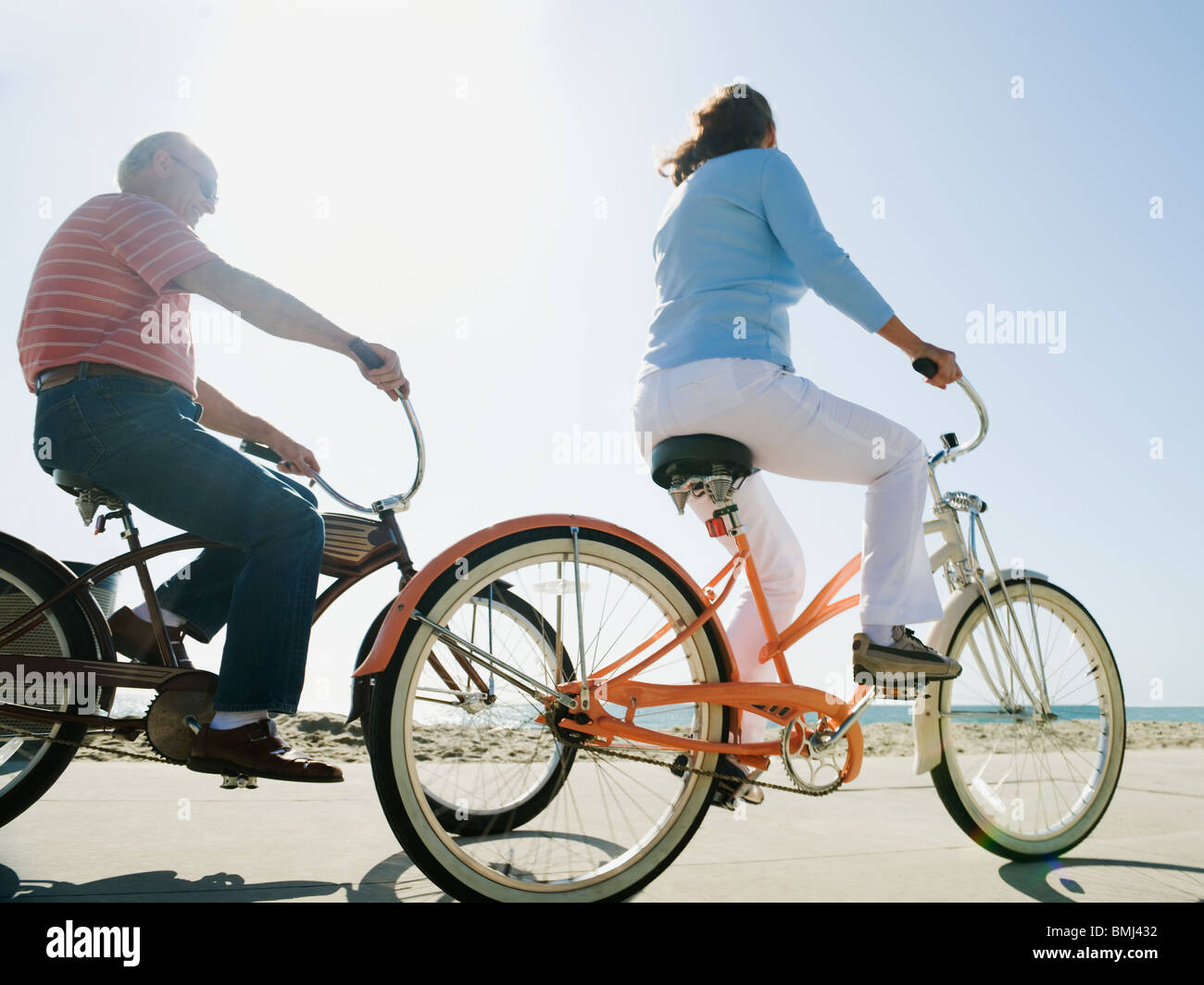 Couple riding bicycles Stock Photo - Alamy
