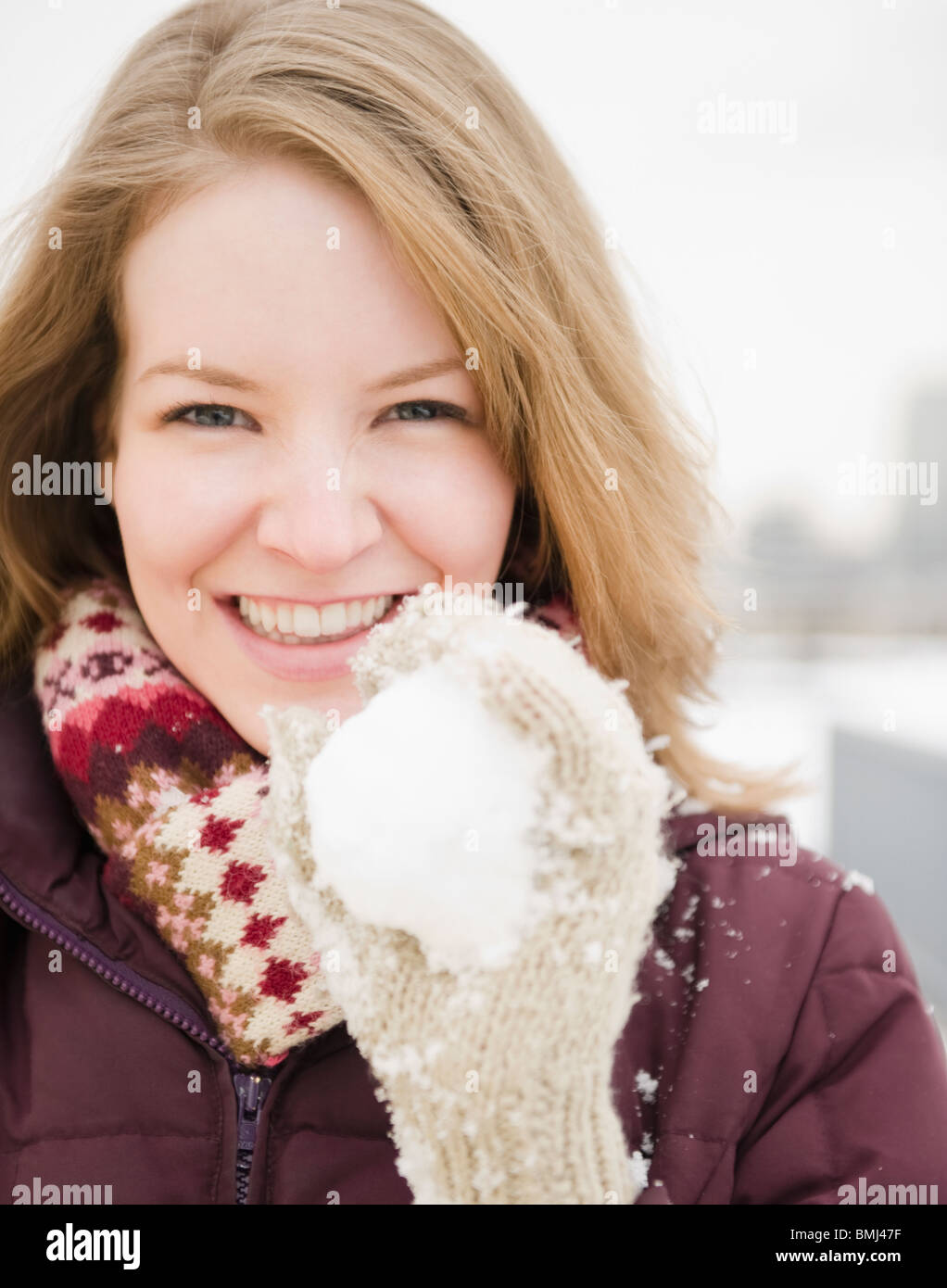 Happy adult woman holding snowballs hi-res stock photography and images ...