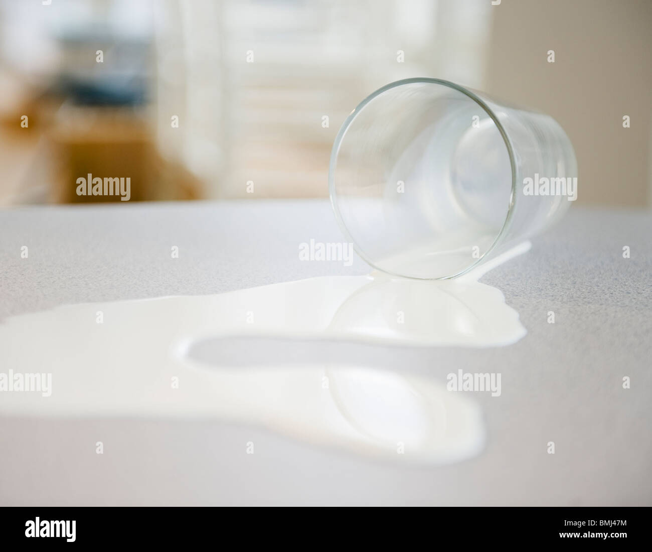 Spilt glass of milk Stock Photo - Alamy