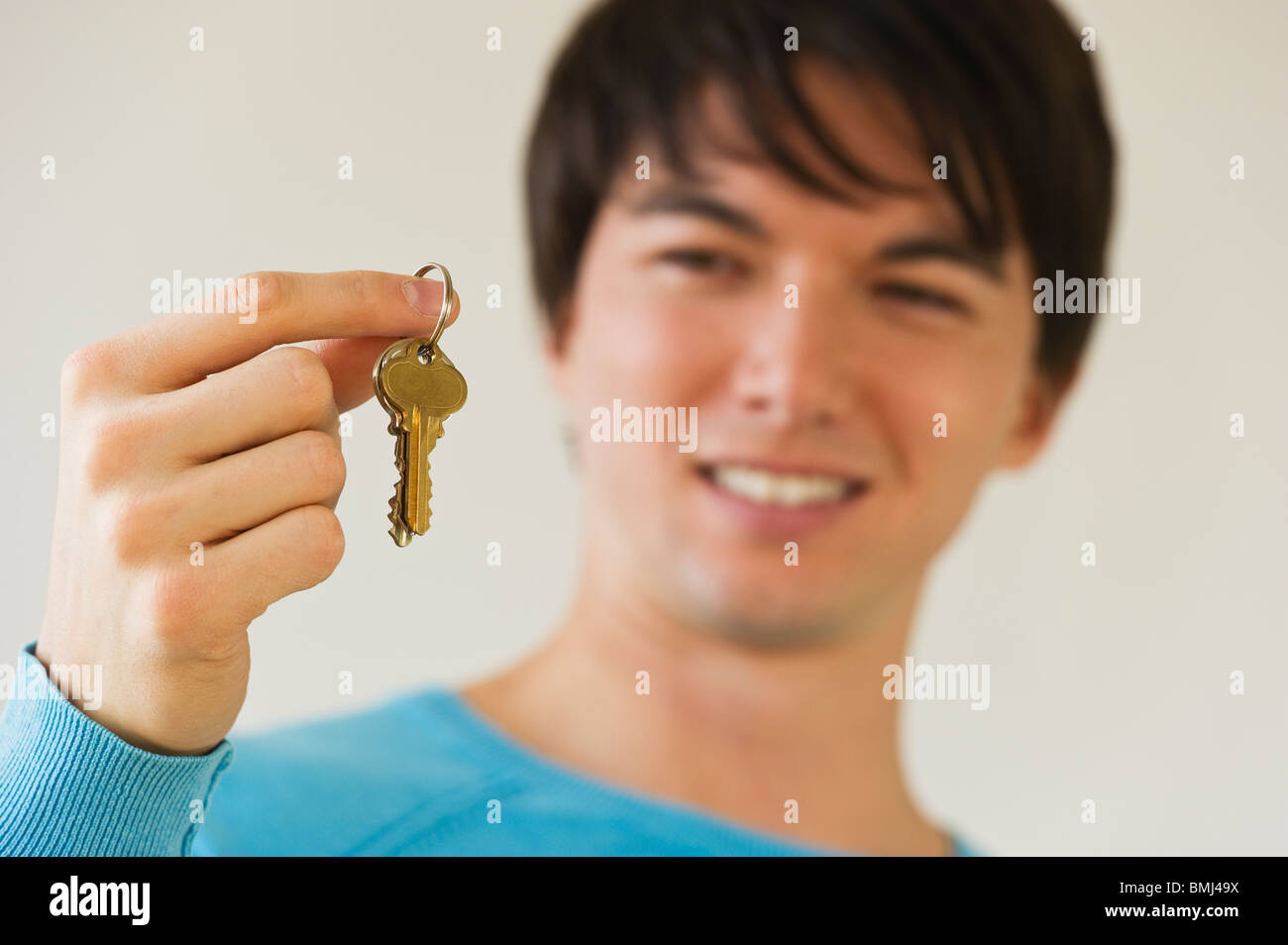 Man holding keys Stock Photo - Alamy