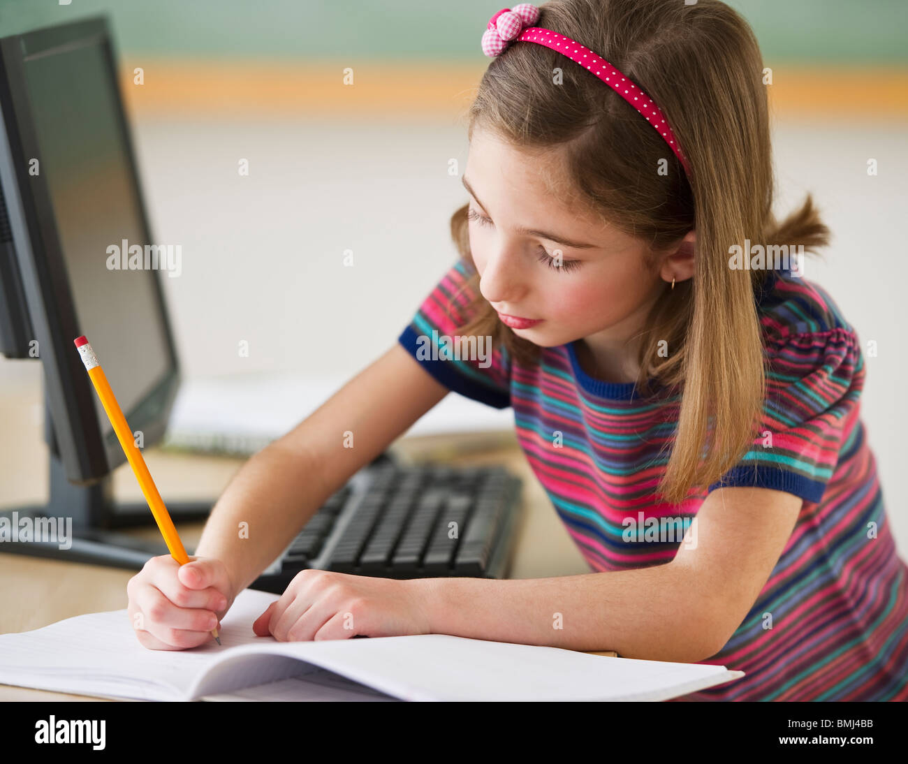 Student writing in notebook Stock Photo - Alamy