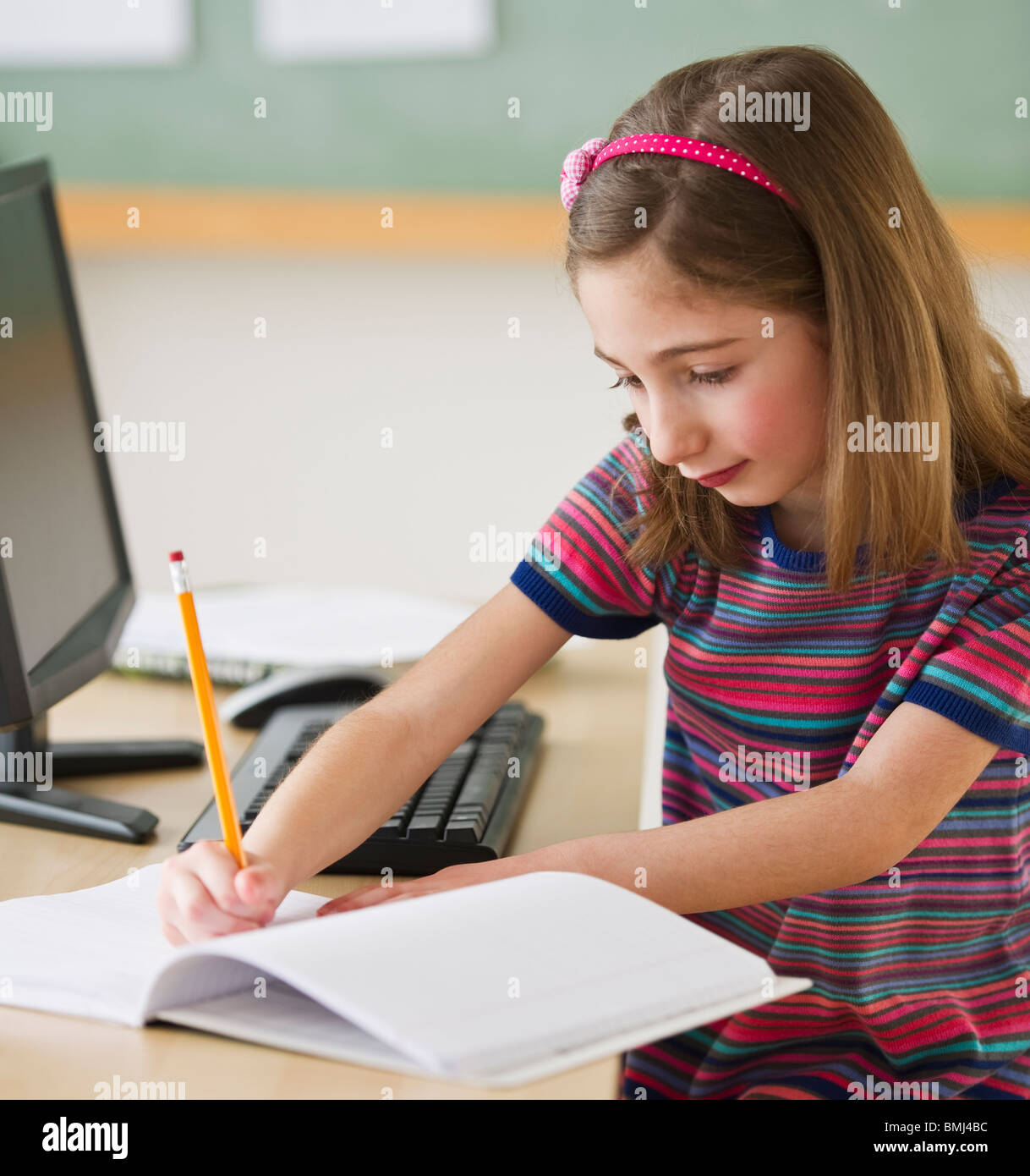 Student writing in notebook Stock Photo - Alamy