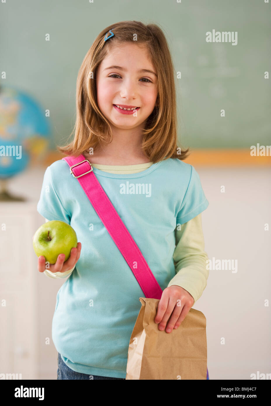 Student in classroom holding lunch Stock Photo - Alamy