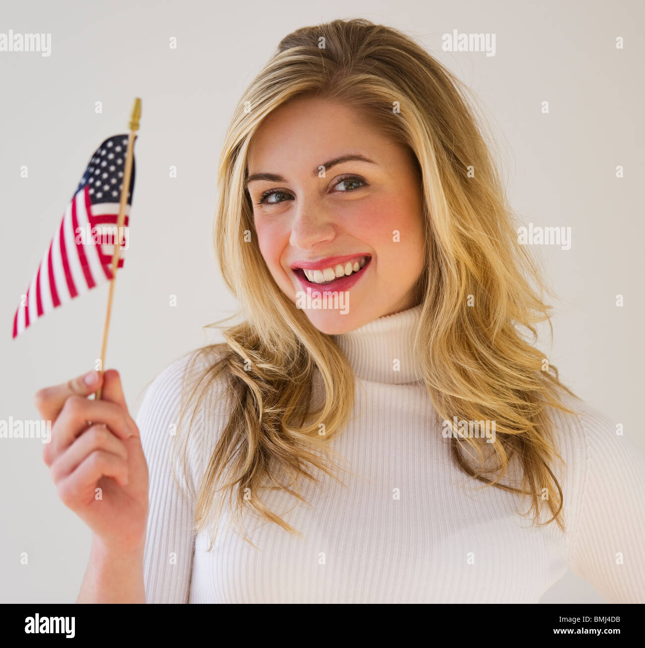 Young woman holding American flag Stock Photo - Alamy