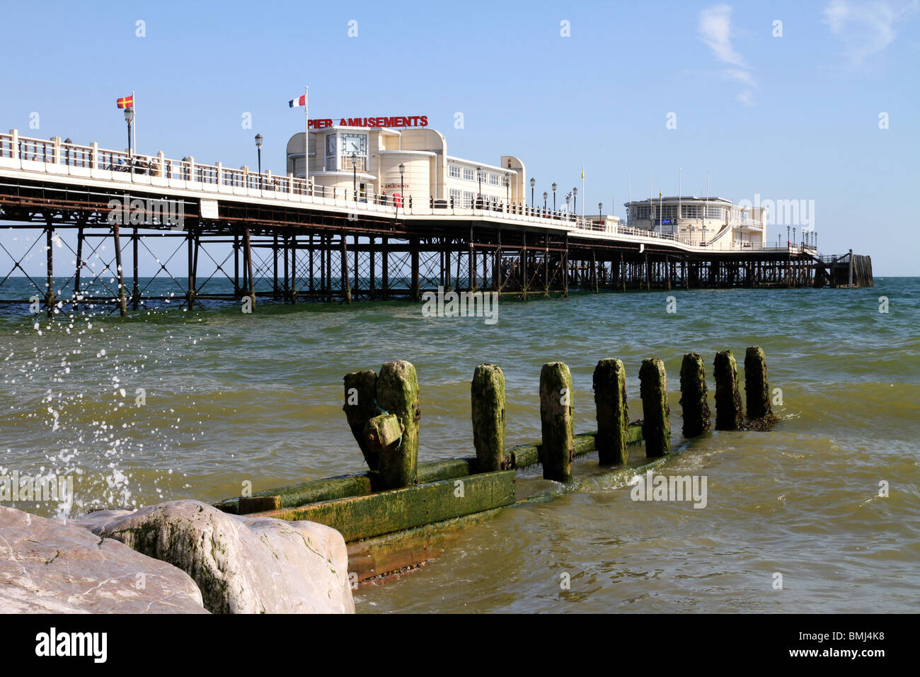 Worthing pier on a sunny day with the groyne and rocks in the ...