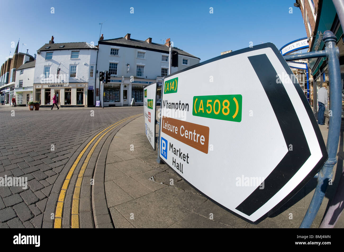 Road signs on a street corner in the market town of Market Harborough ...