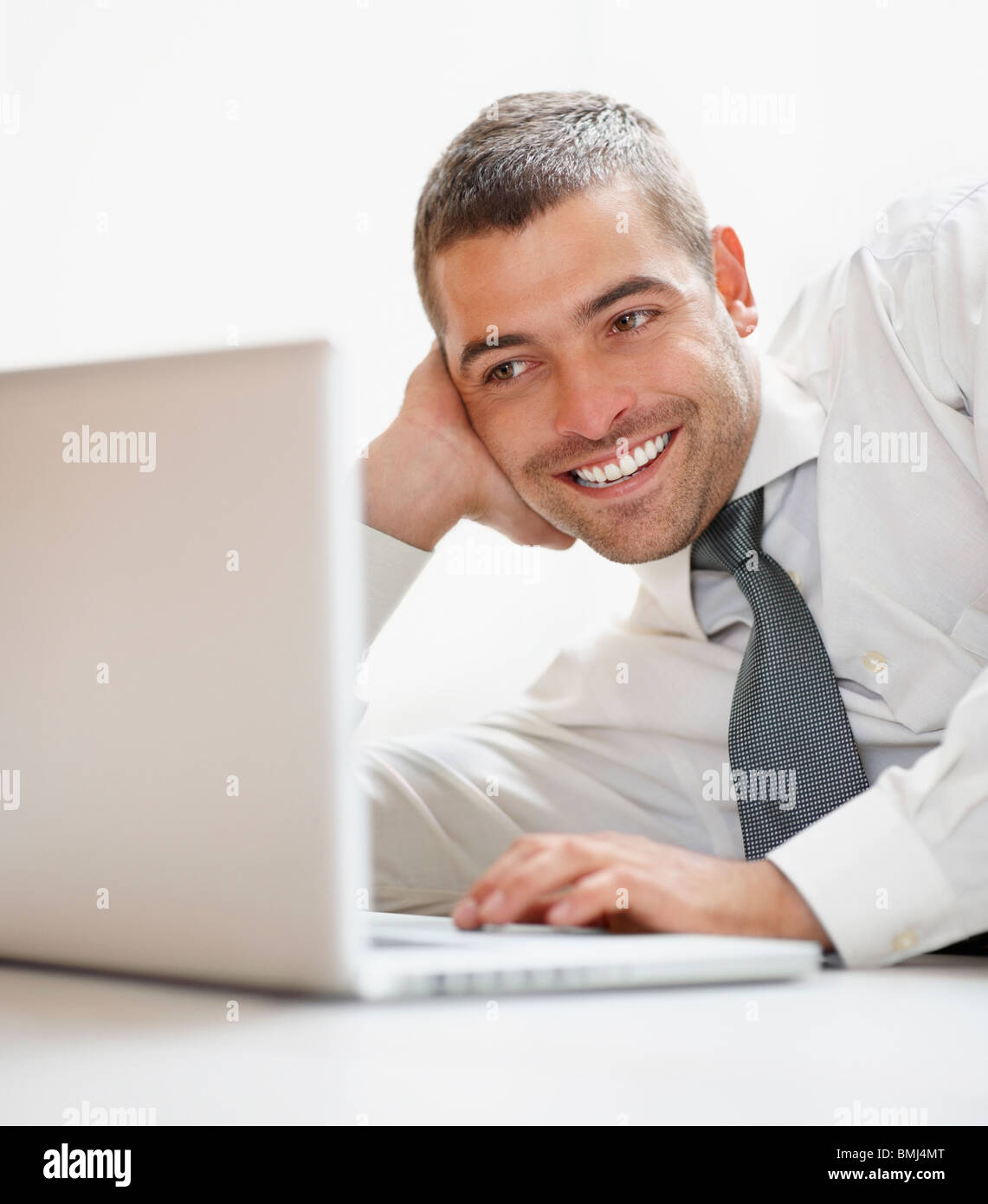 Businessman looking at computer Stock Photo - Alamy