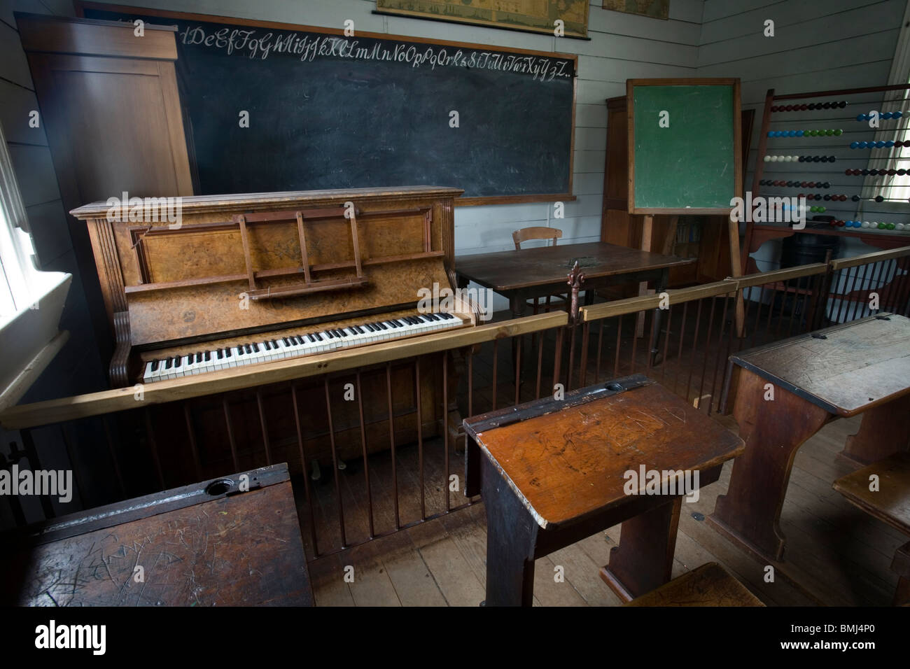 A nineteenth (XIX) century (1800s) classroom with wooden benches, a ...