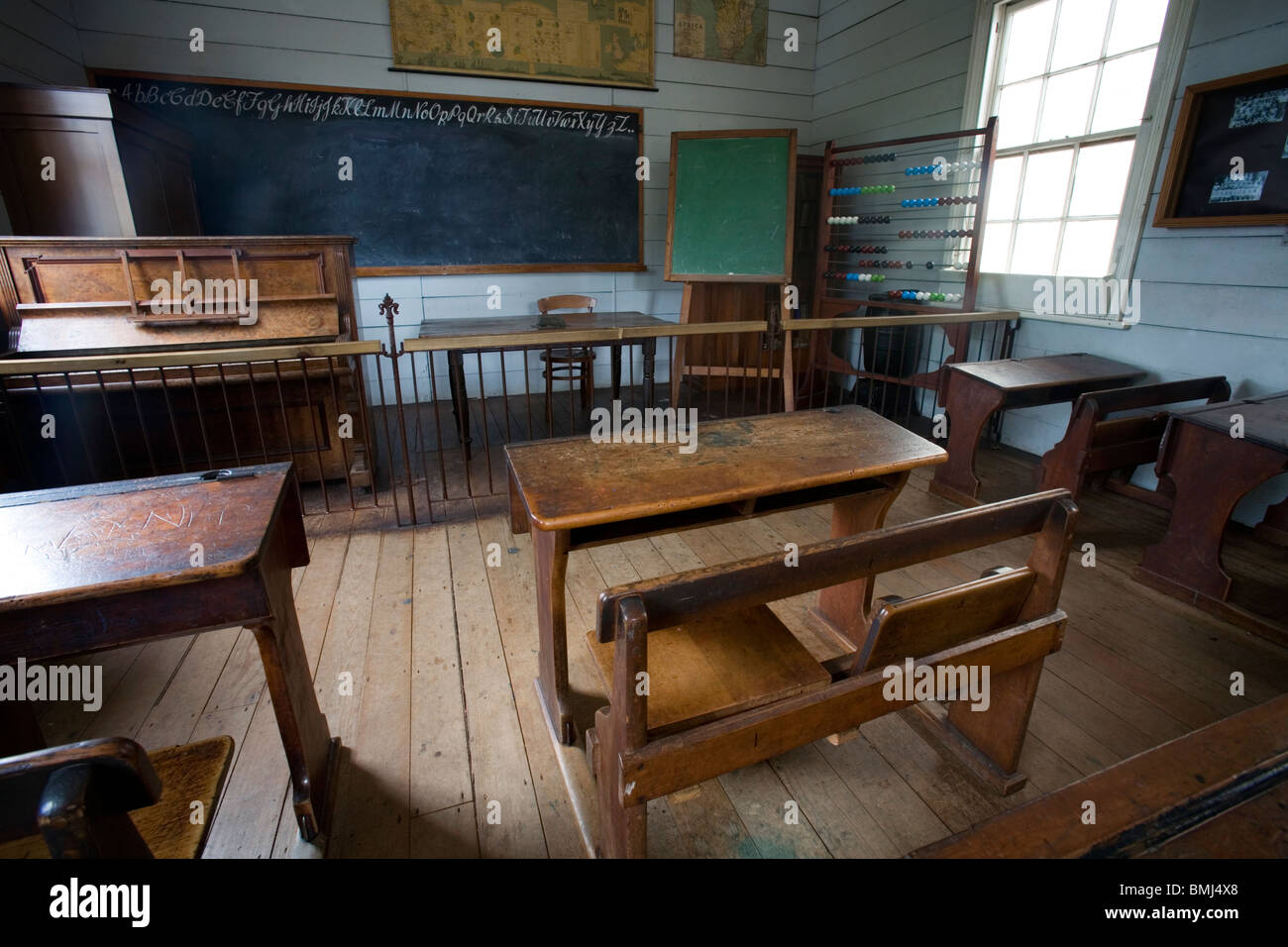 A nineteenth (XIX) century (1800s) classroom with wooden benches, a ...