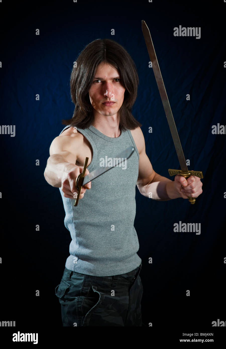 A young man with two swords Stock Photo - Alamy