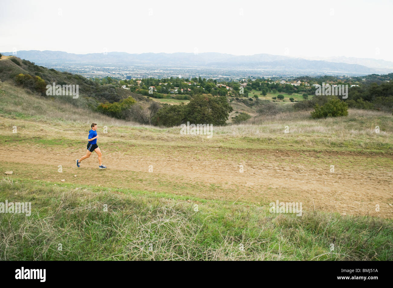 Person running on trail Stock Photo - Alamy