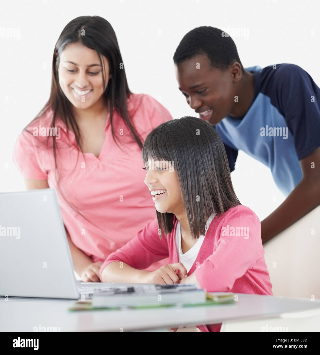 Students looking at laptop Stock Photo - Alamy