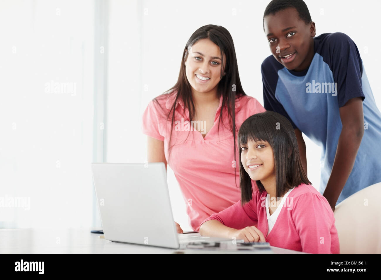 Students looking at laptop Stock Photo - Alamy