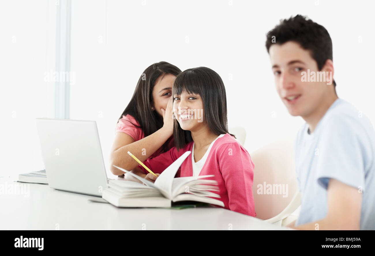 Students whispering classroom Stock Photo - Alamy