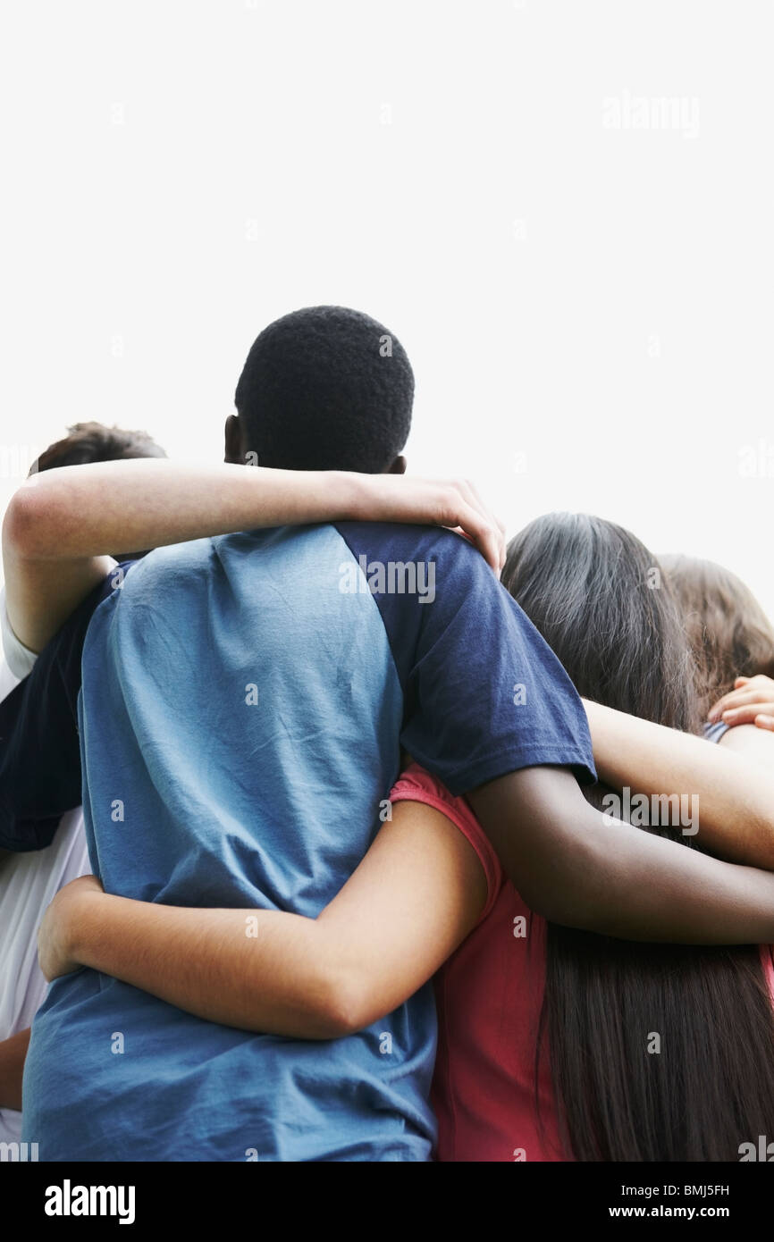 Friends huddled together Stock Photo - Alamy