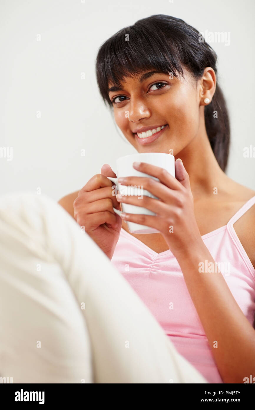 Young woman drinking coffee Stock Photo - Alamy