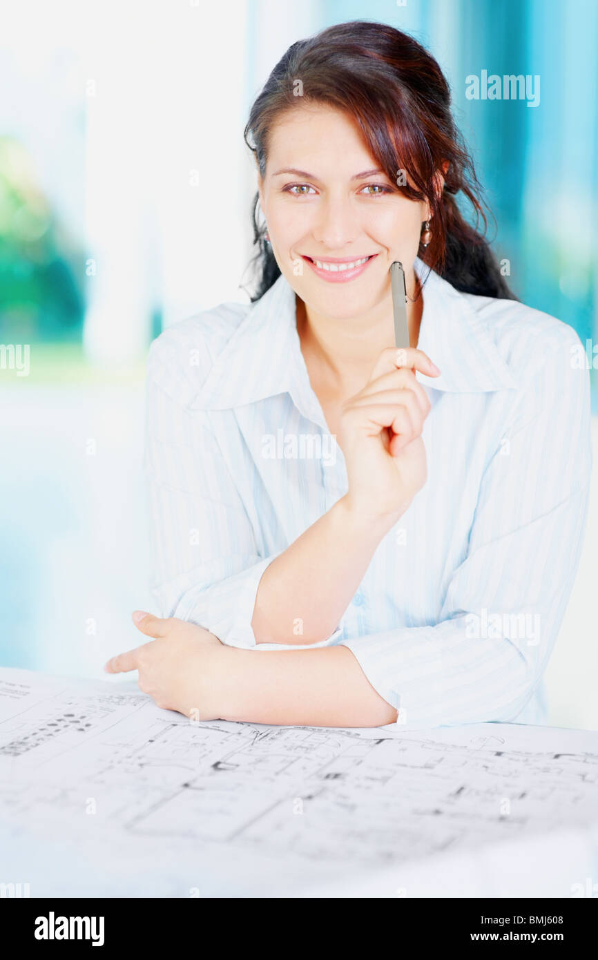 Woman looking at blueprints Stock Photo - Alamy