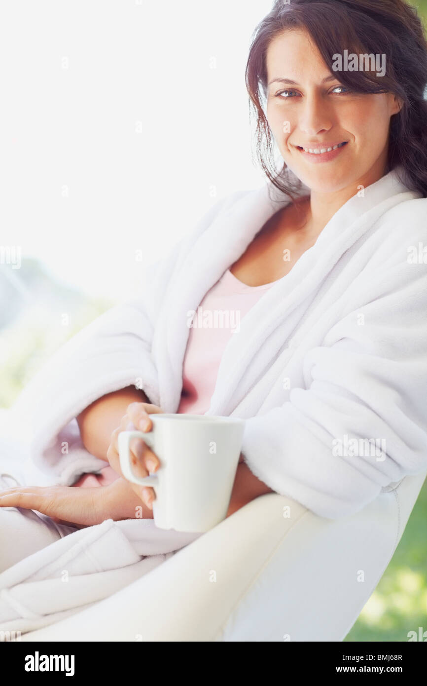 Woman in bathrobe drinking coffee Stock Photo - Alamy