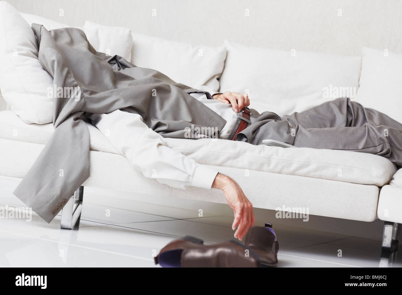 Businessman napping on couch hi-res stock photography and images - Alamy