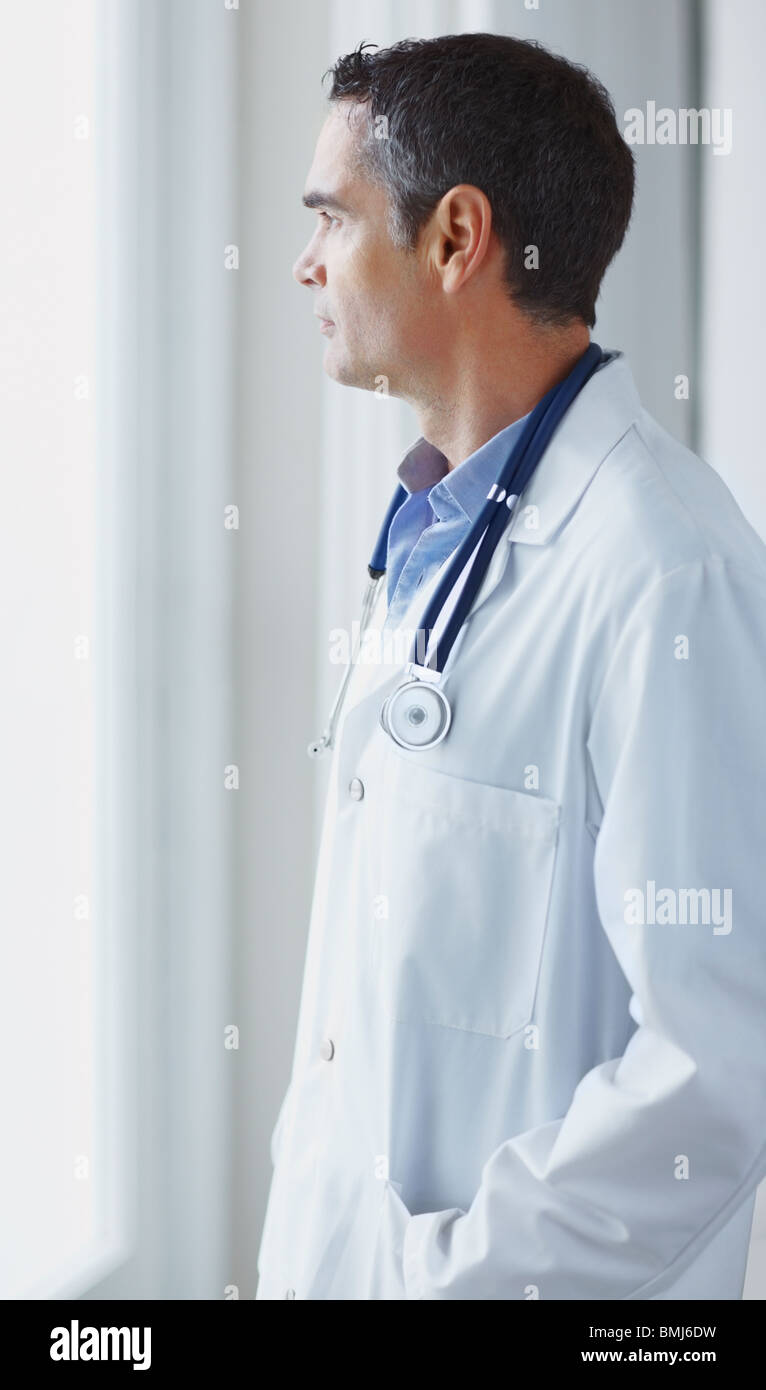 Doctor looking out window Stock Photo - Alamy