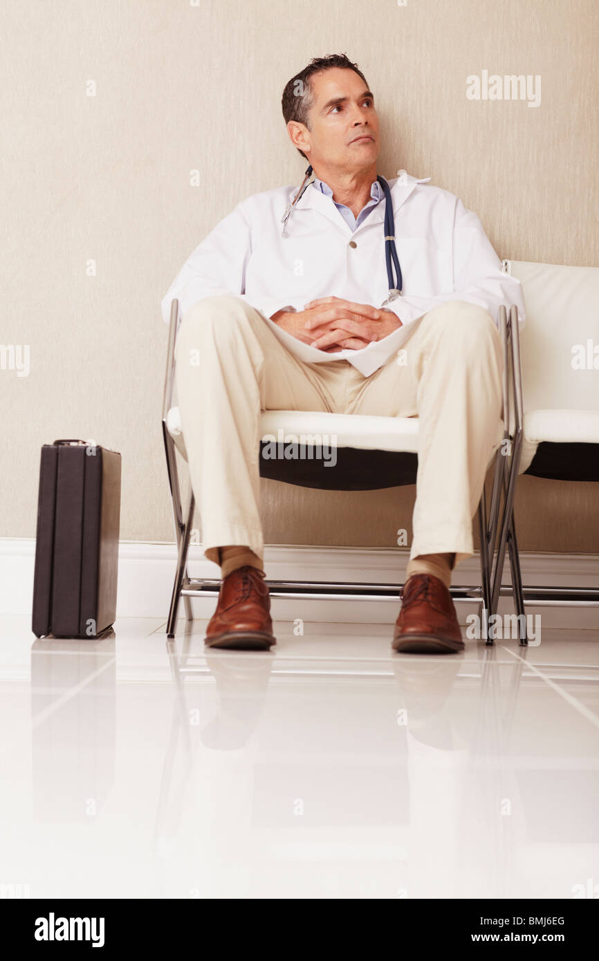 Doctor sitting in waiting room Stock Photo - Alamy