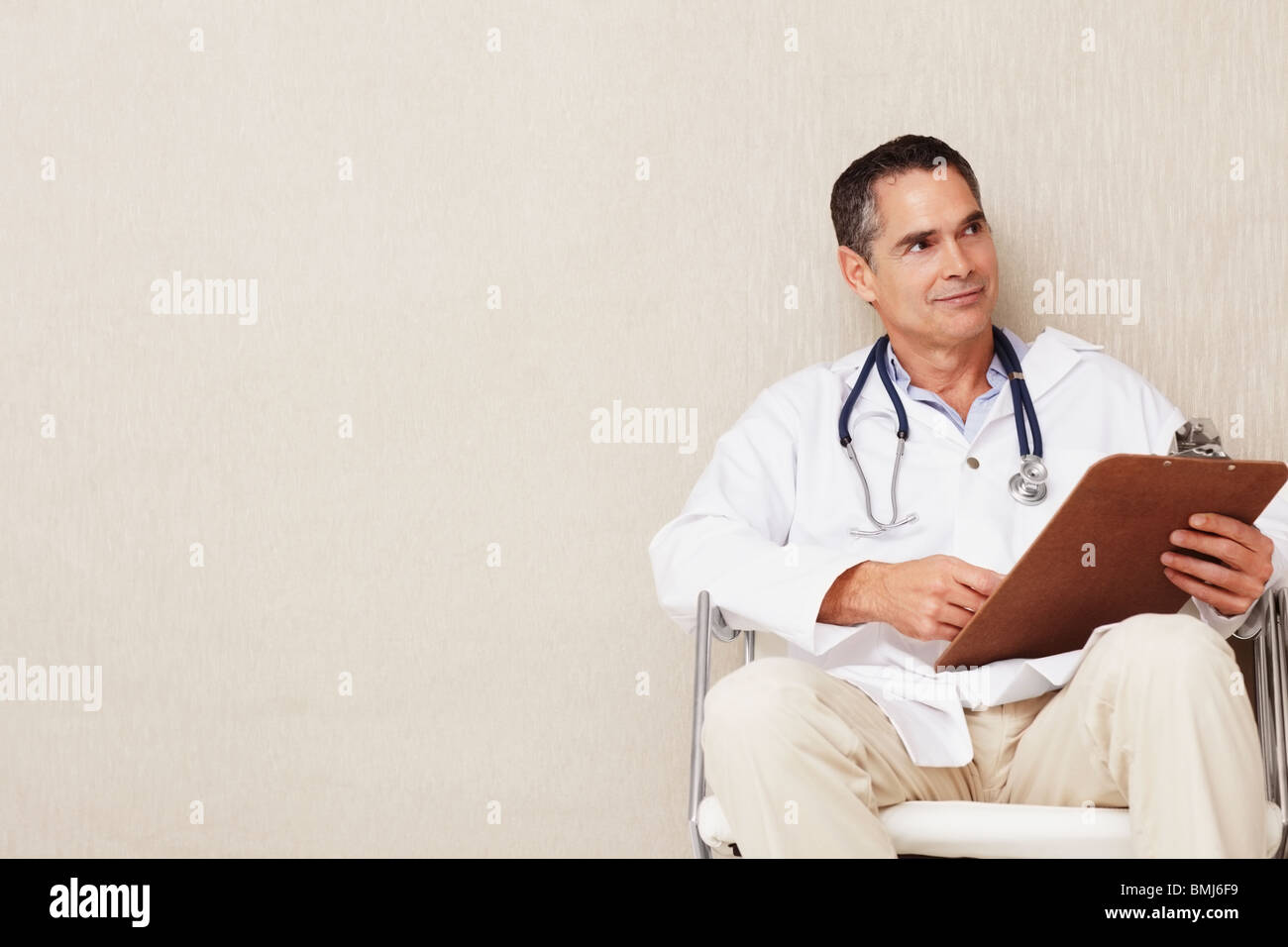 Doctor sitting in waiting room Stock Photo - Alamy