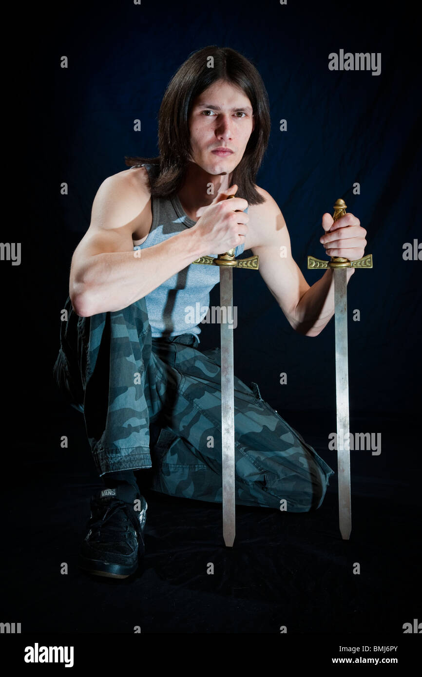 A young man with two swords Stock Photo - Alamy