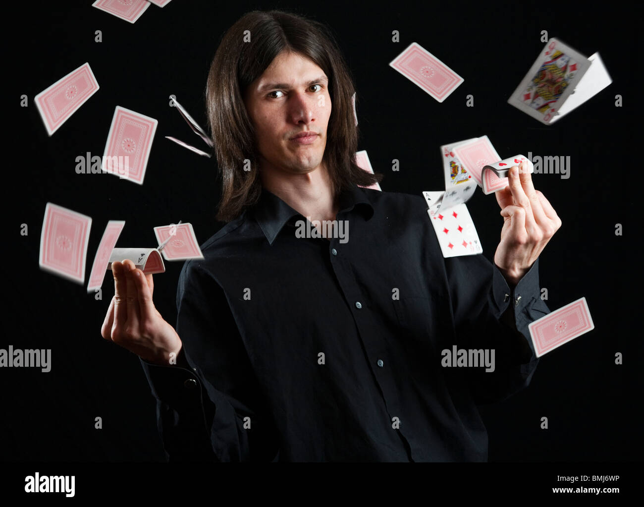 A young man throws cards in the air Stock Photo - Alamy