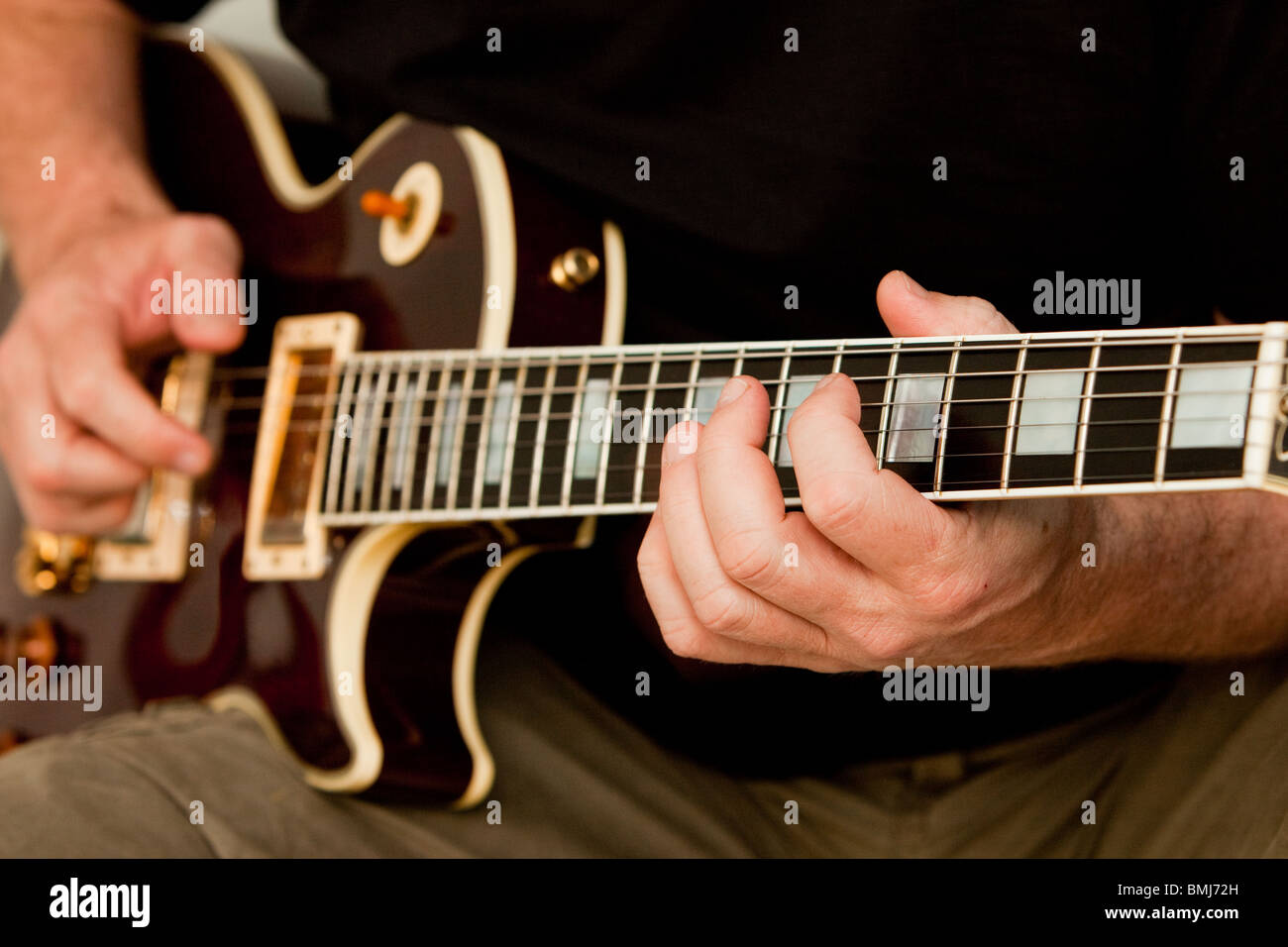 Close up of a an electric guitar being played Stock Photo - Alamy