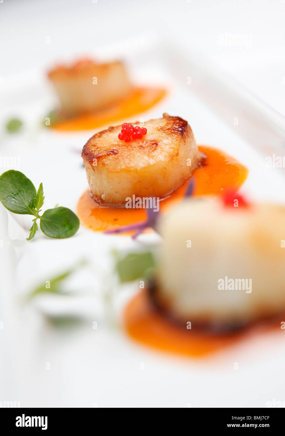 Scallops served in a tomato sauce, Mezze style, in a restaurant Stock ...