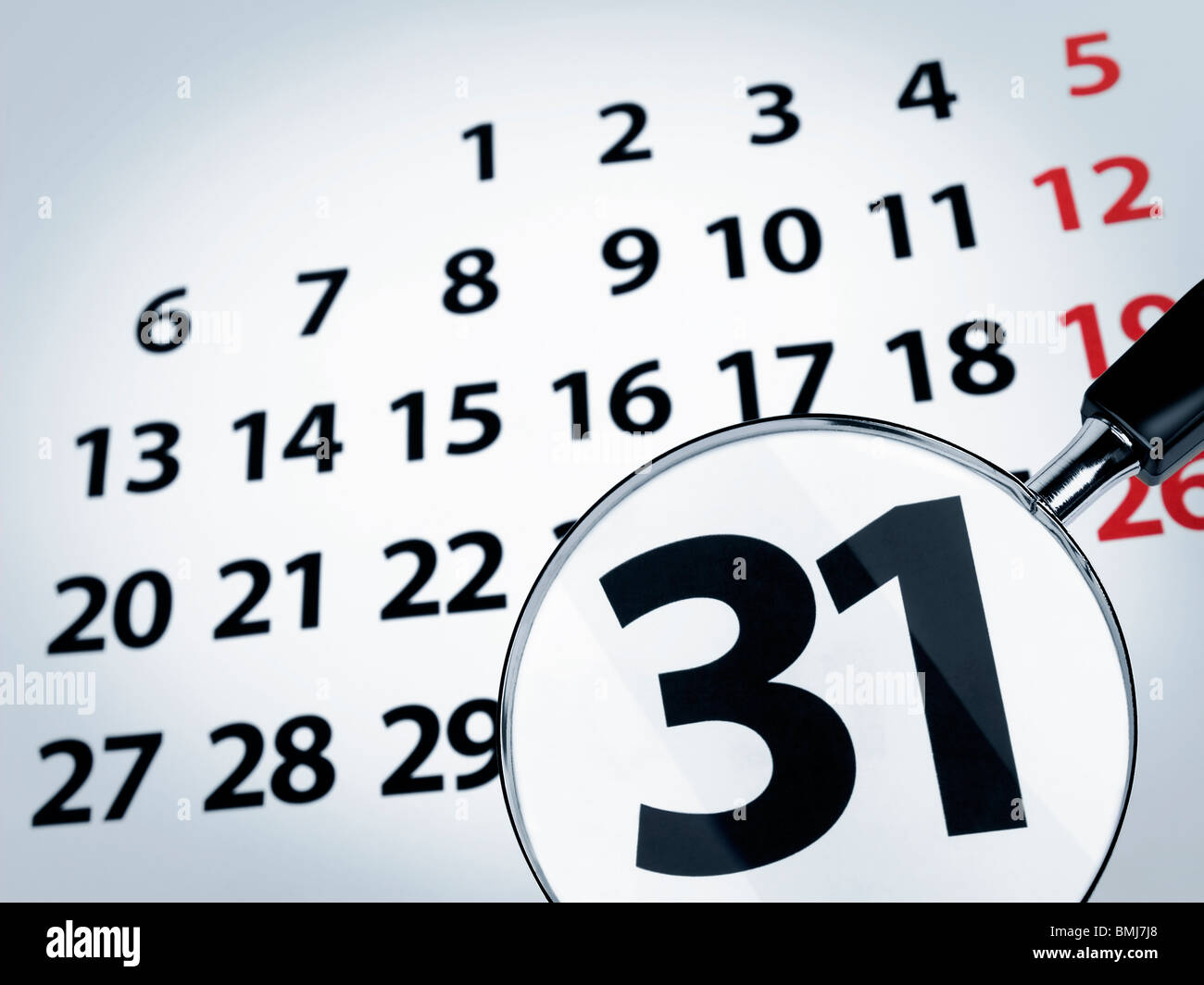 A magnifying glass on the 31st day of a calendar page Stock Photo - Alamy