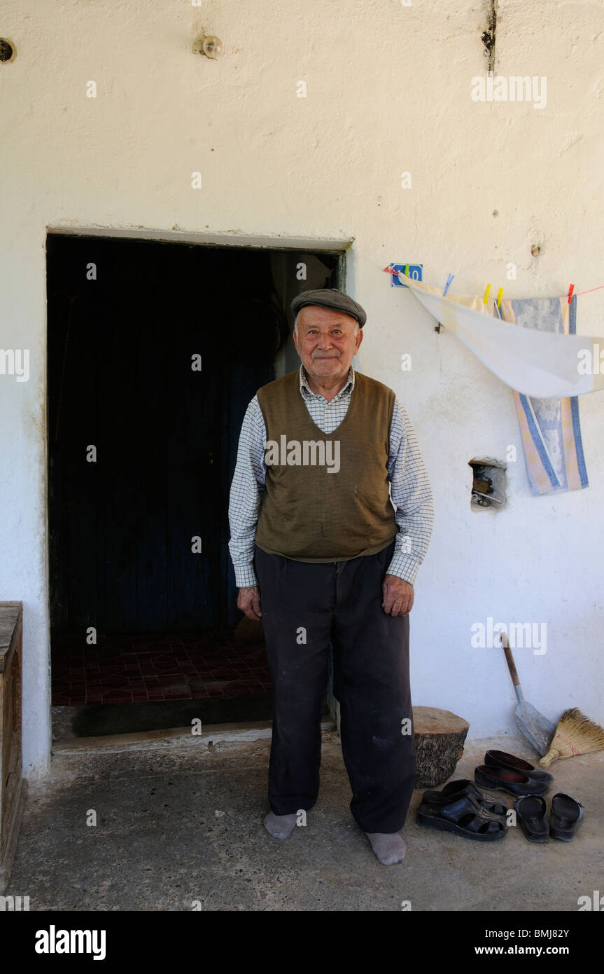 Elderly resident of the Turkish village Etrim standing outside the door ...