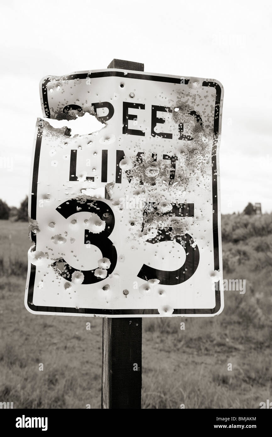Bullet scarred and shot out road sign. Idaho USA Stock Photo - Alamy