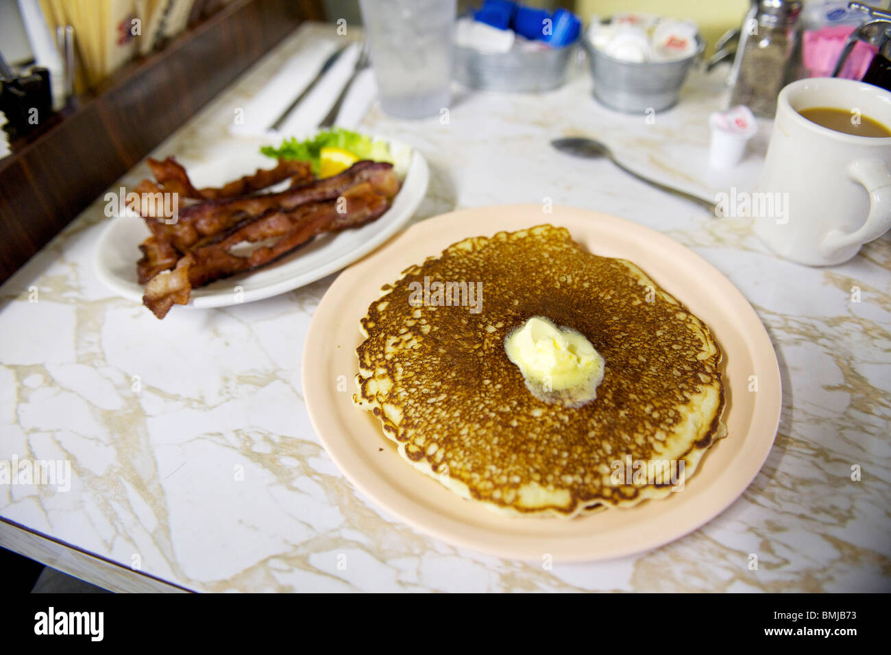 Pancake and bacon with melted butter. Montana truck stop cafe Stock ...