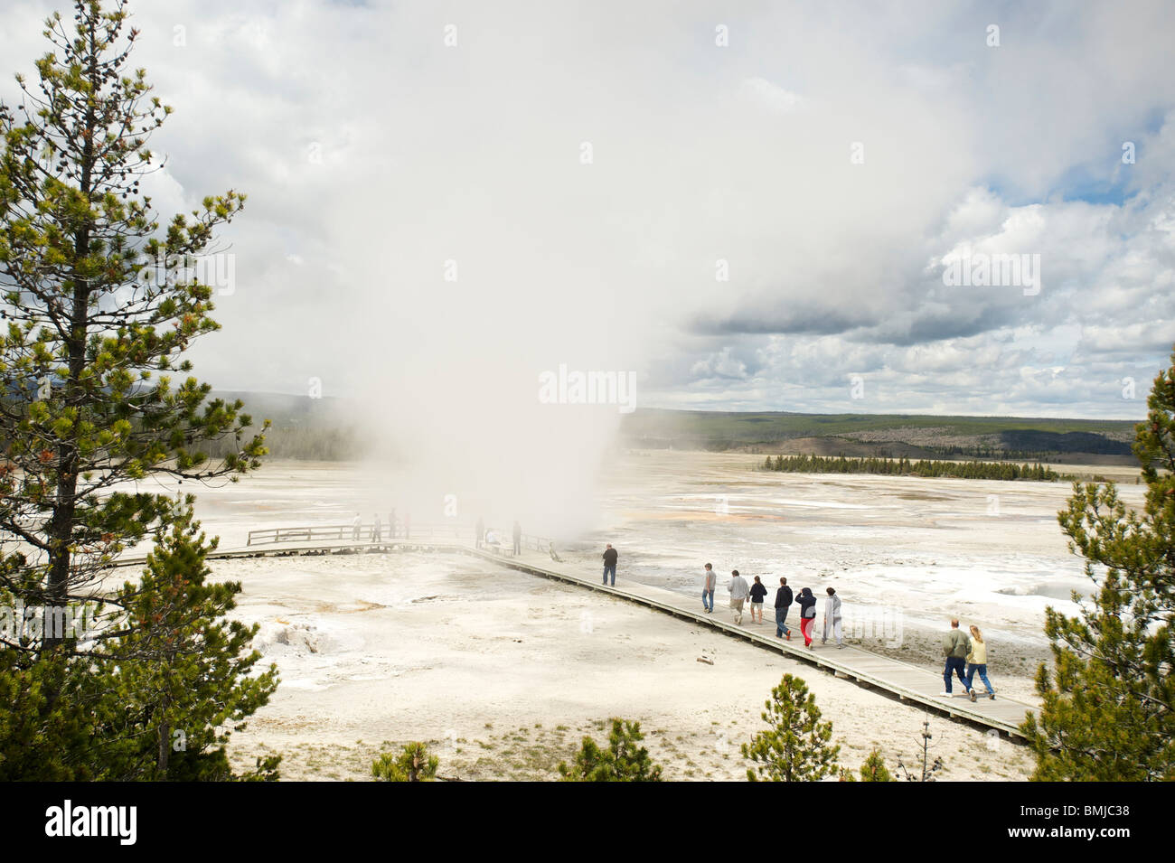 Tourist at geothermal geysers in Yellowstone National Park. Wyoming ...