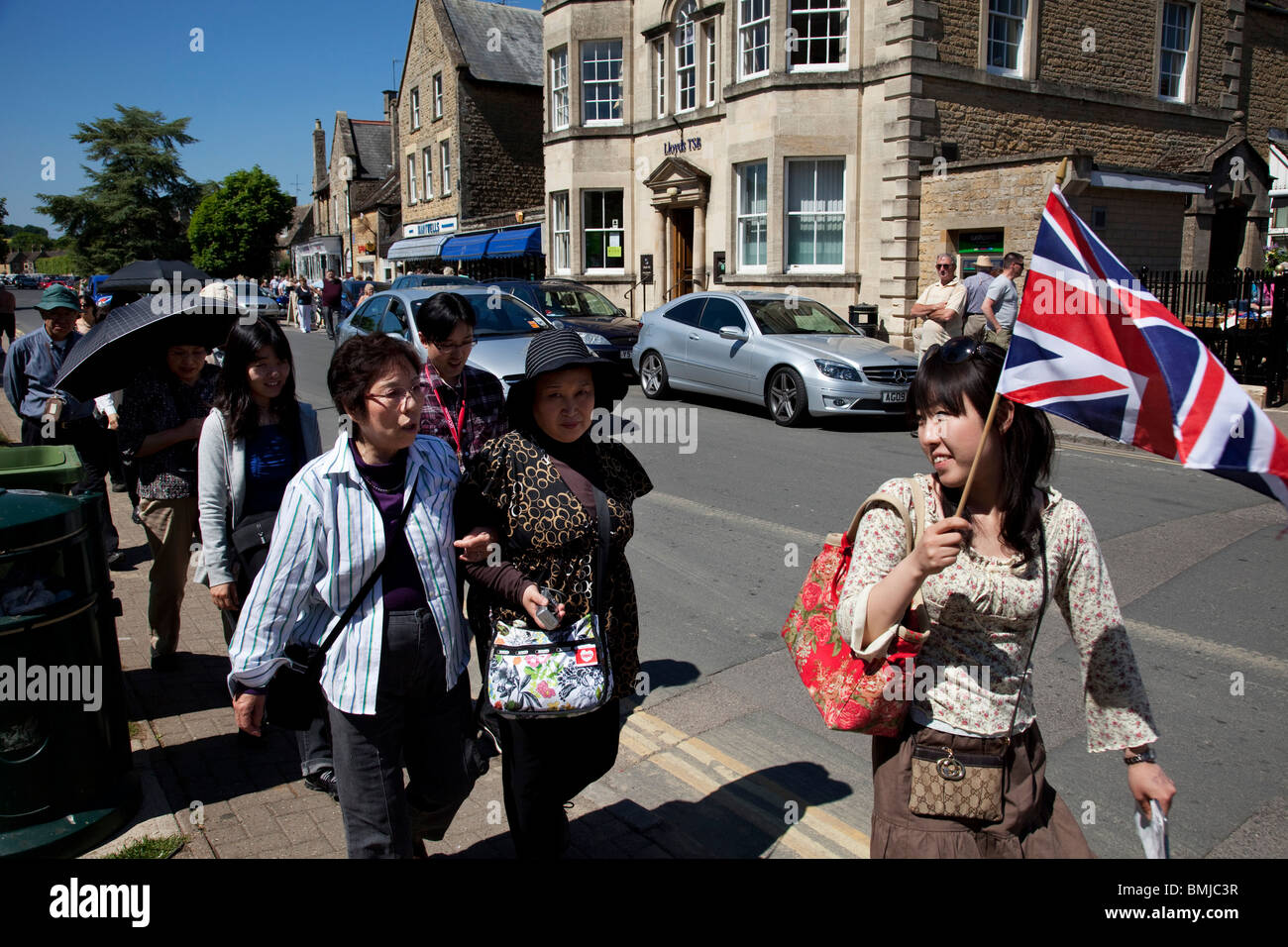 Chinese tourists take a guided tour at Bourton-on-the-Water in The ...