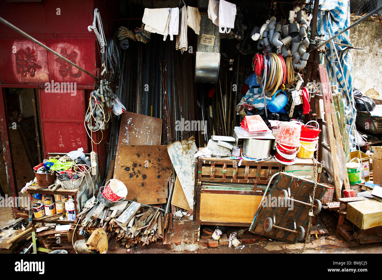 A rubbish recycling shop front with mountains of reusable material such ...