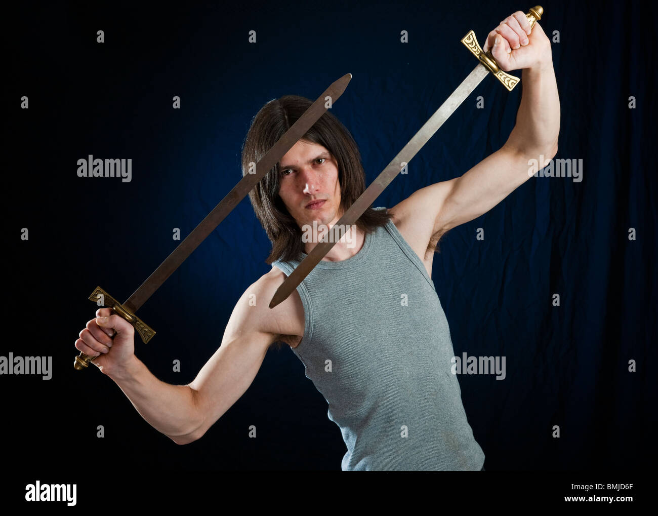 A young man with two swords Stock Photo - Alamy