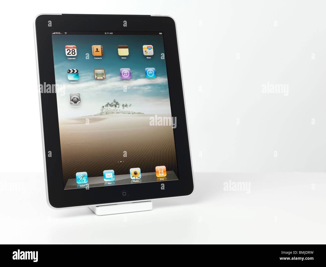 Apple iPad 3G tablet computer standing in its dock isolated on white ...