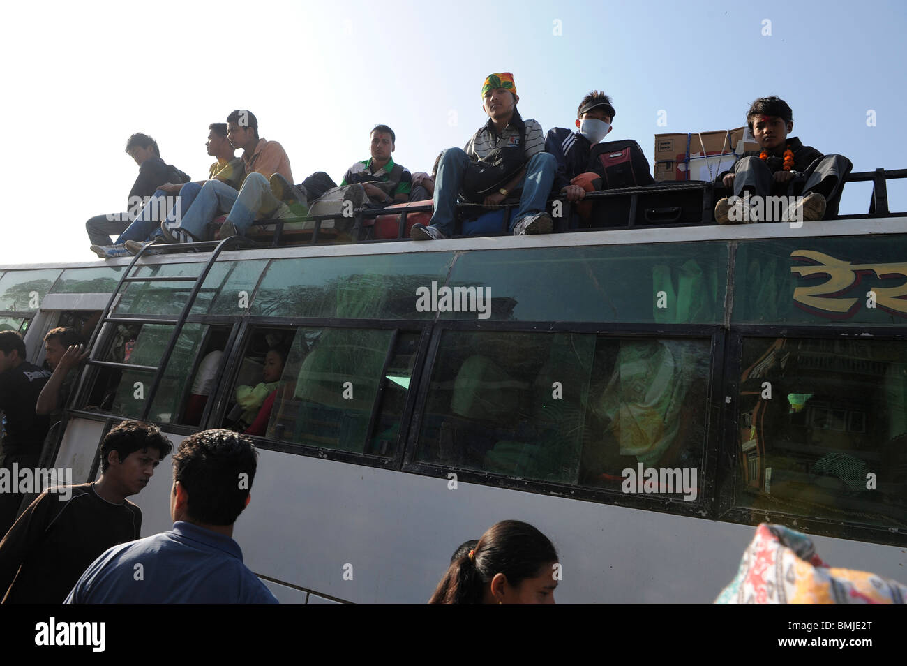 hitching a lift on top of bus , pit stop at thimi, main road from ...
