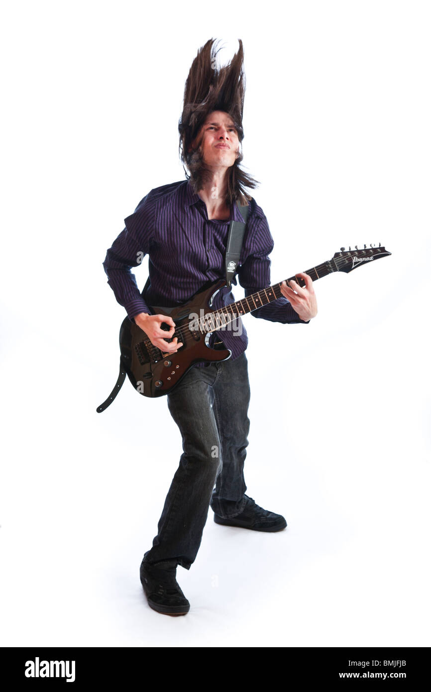 A young man headbanging while playing a guitar Stock Photo - Alamy