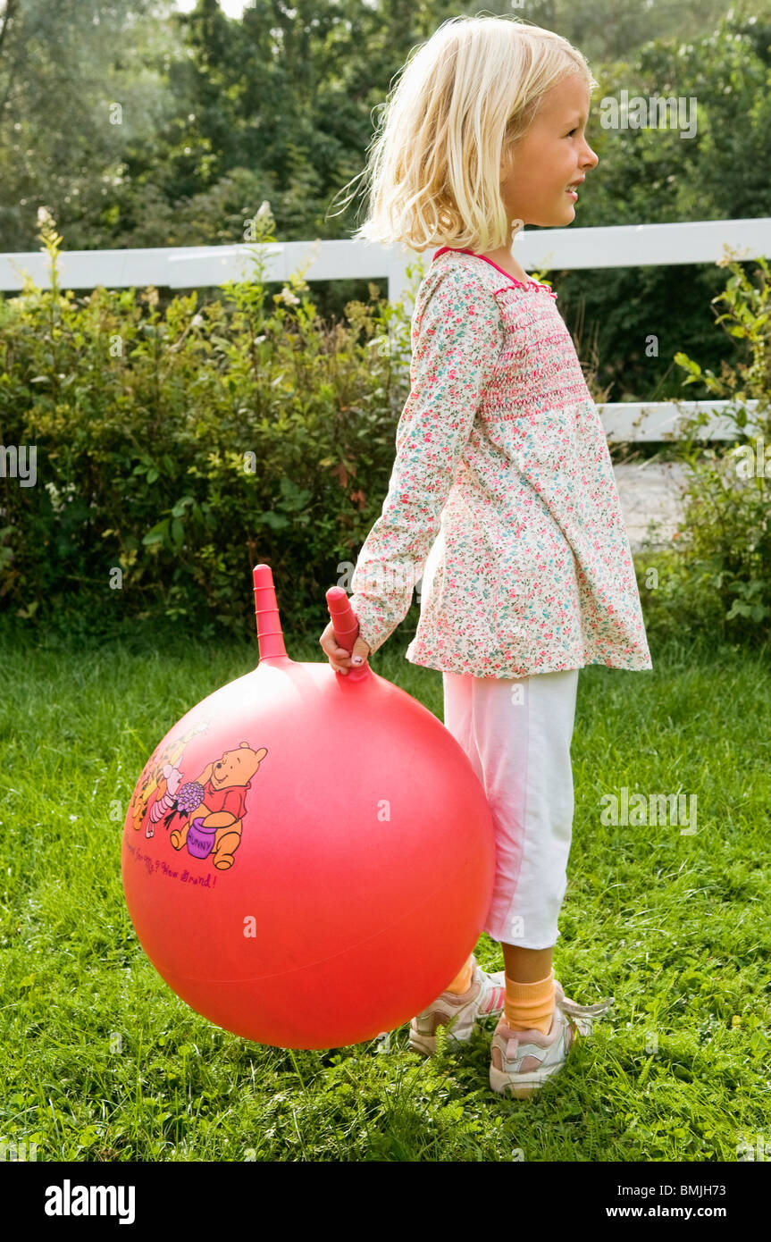 Girl on bouncing ball playing hi-res stock photography and images - Alamy
