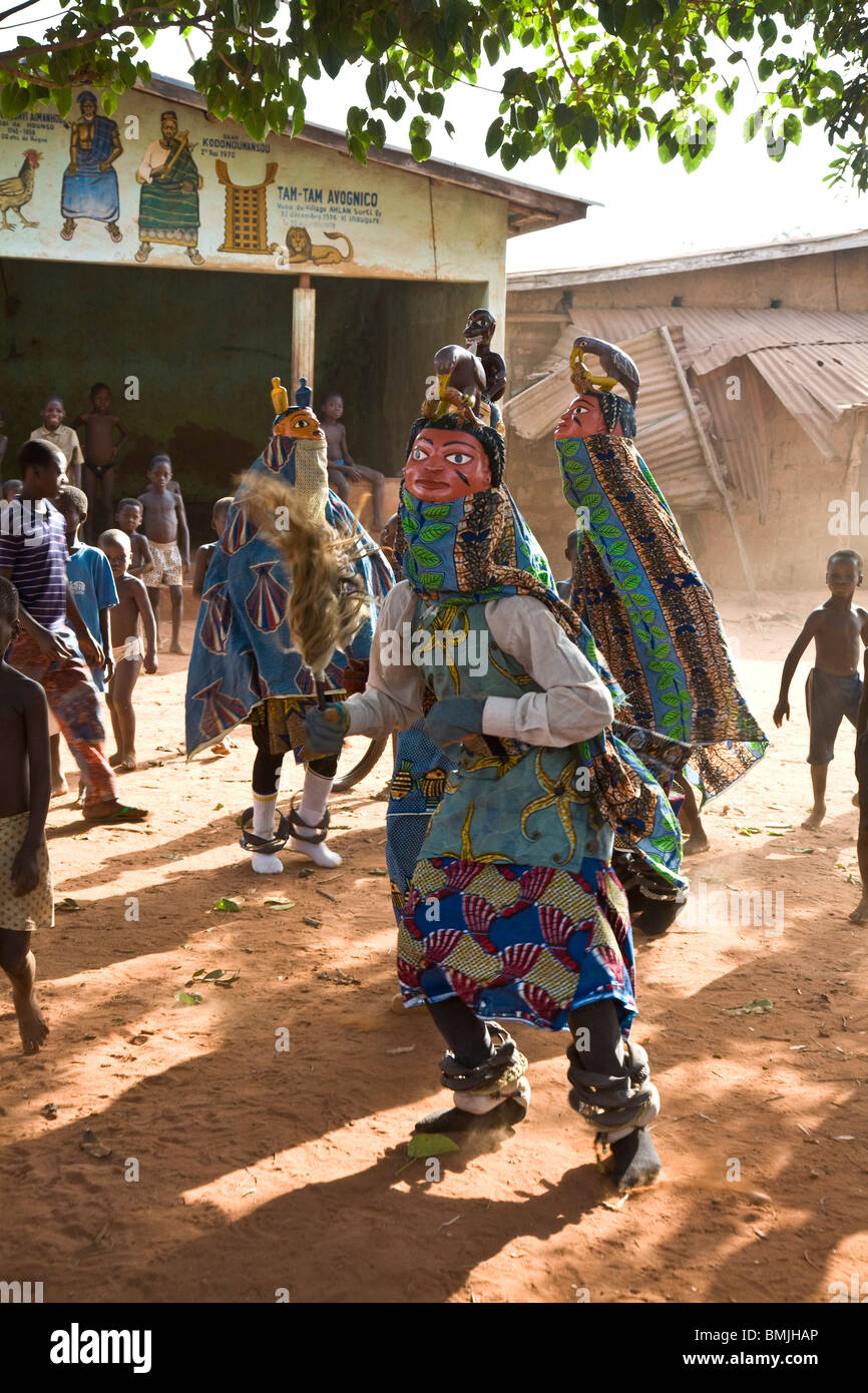 West Africa, Benin. Gelede Mask Dancers perform as children watch Stock ...