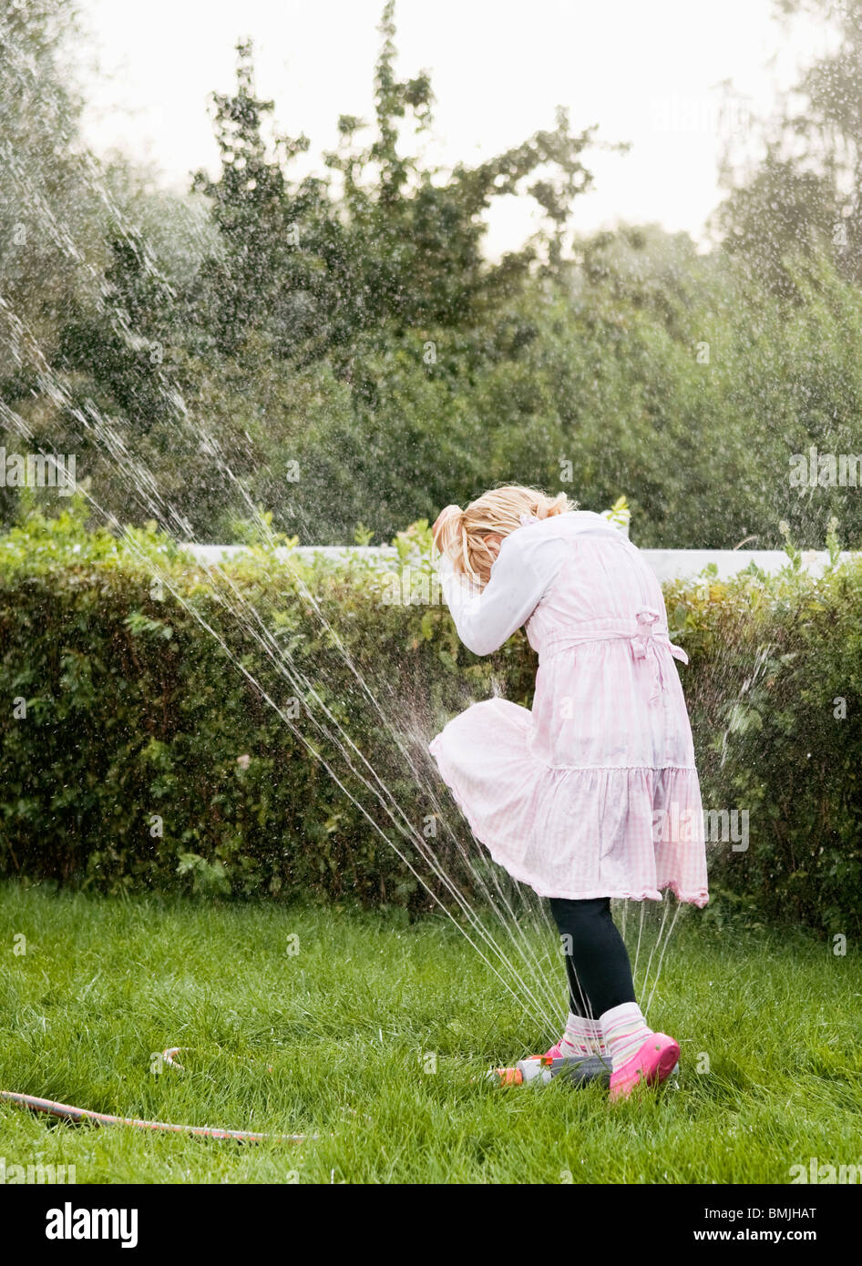 Girls playing water spray happiness hi-res stock photography and images ...