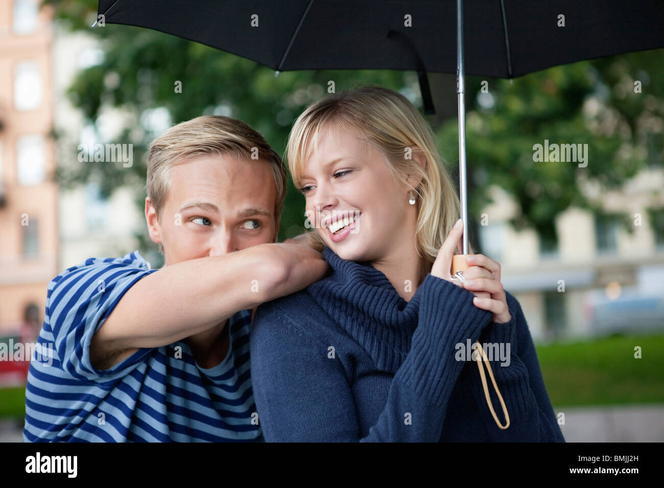 Hiding under umbrella hi-res stock photography and images - Alamy