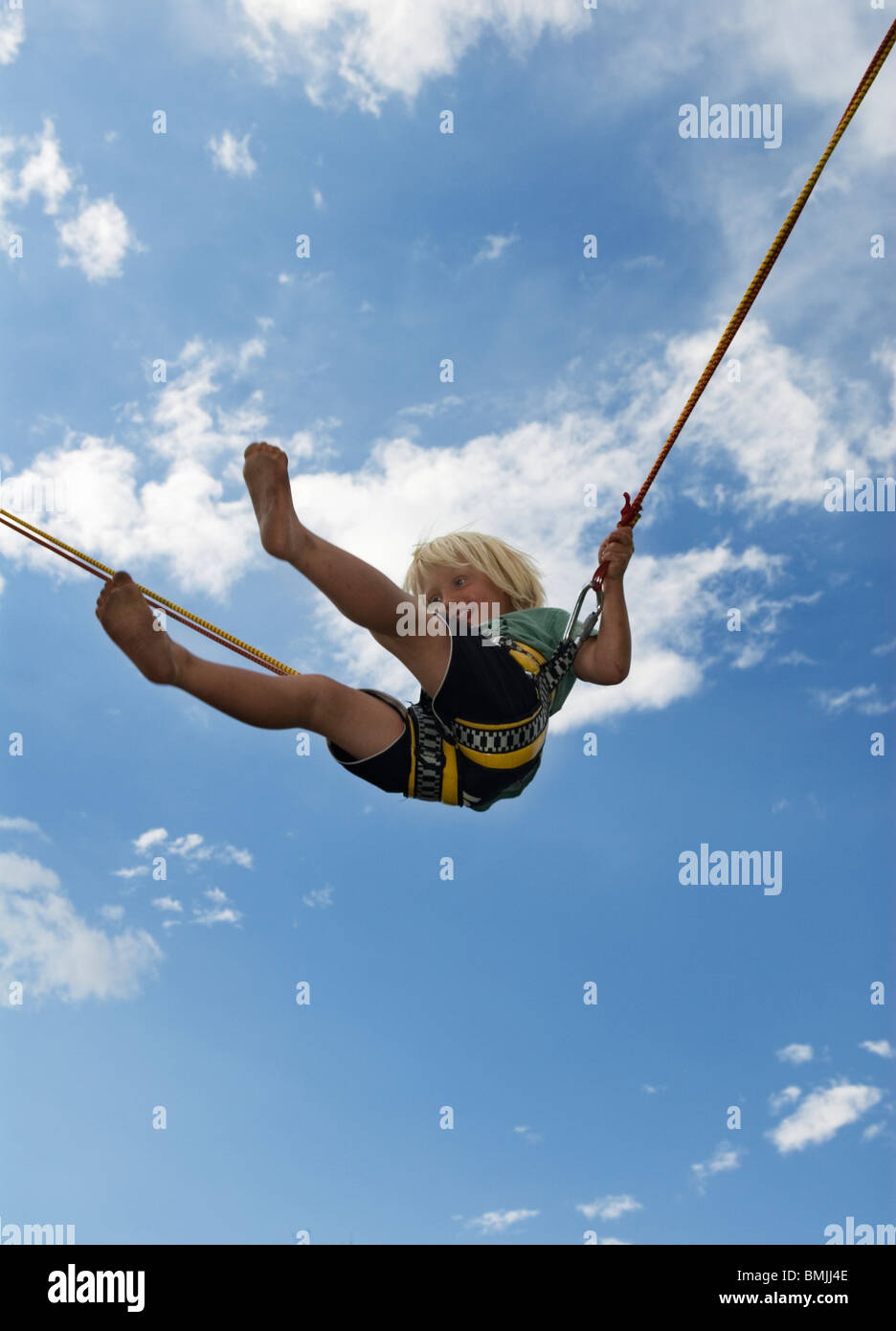 Scandinavia, Sweden, Ostergotland, Linkoping, Boy playing on bungee ...