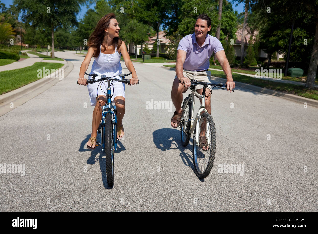 Two attractive adults, man and woman couple, cycling together Stock ...
