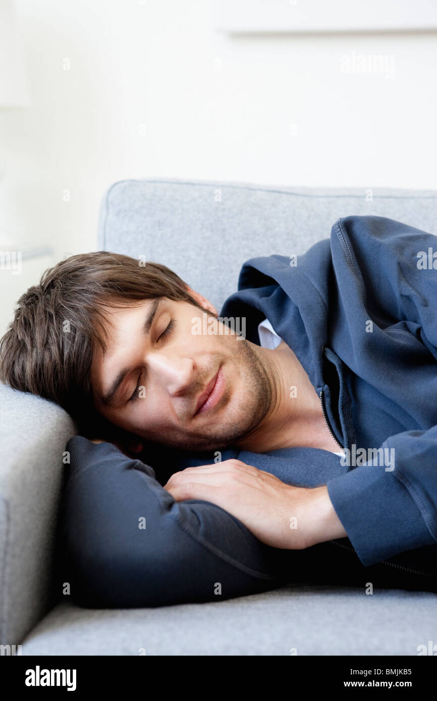 Man asleep on settee hi-res stock photography and images - Alamy