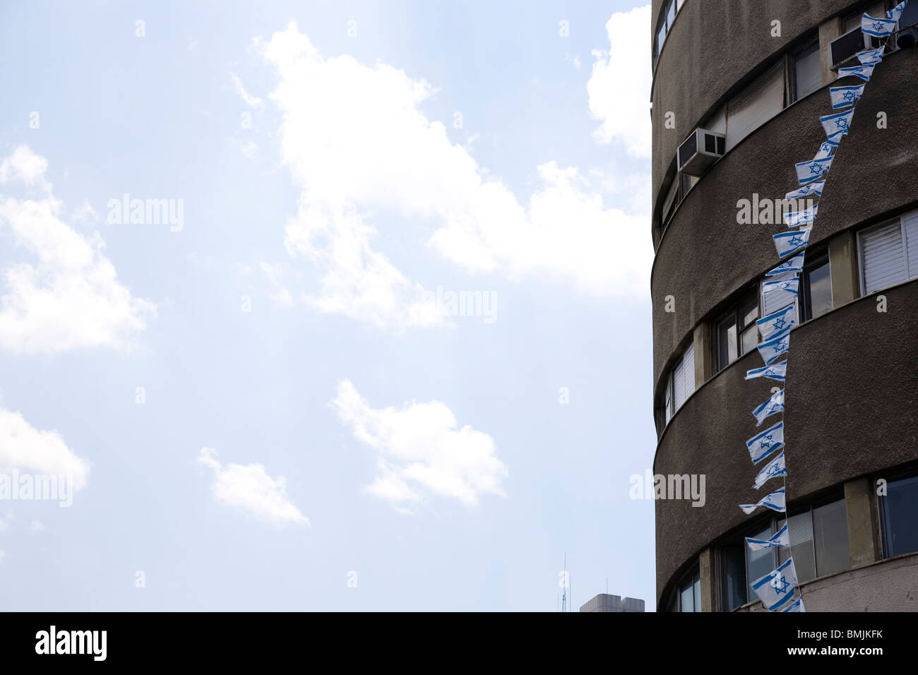 Side of concrete building with Israeli flags Stock Photo - Alamy